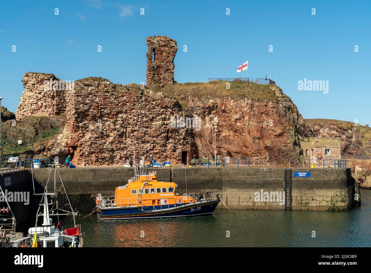 Dunbar Castle at Victoria harbour with boats mooring; Dunbar, East ...