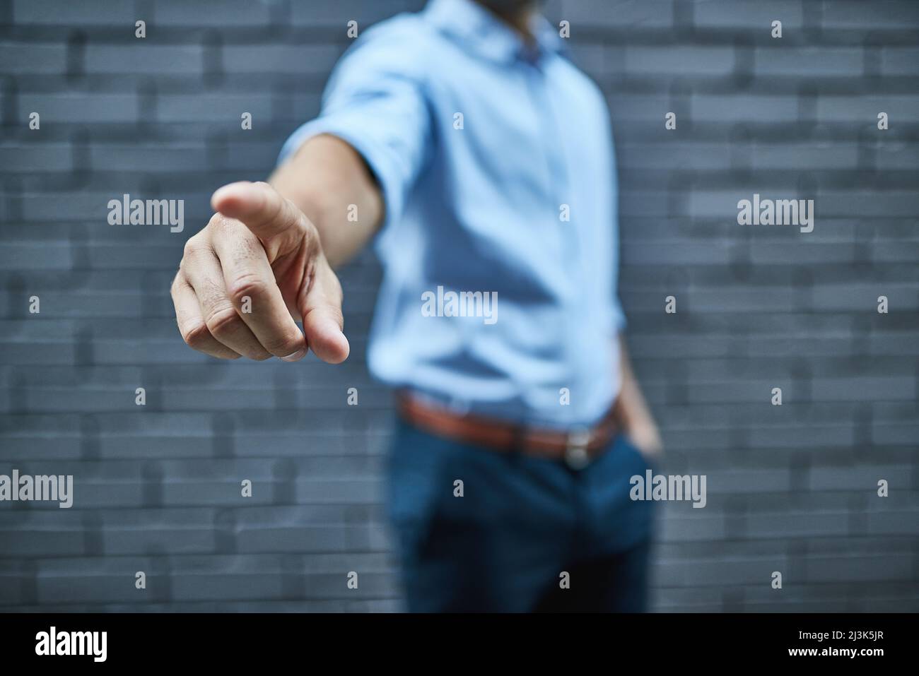 At the touch of a finger. Shot of a man pointing his finger forward ...