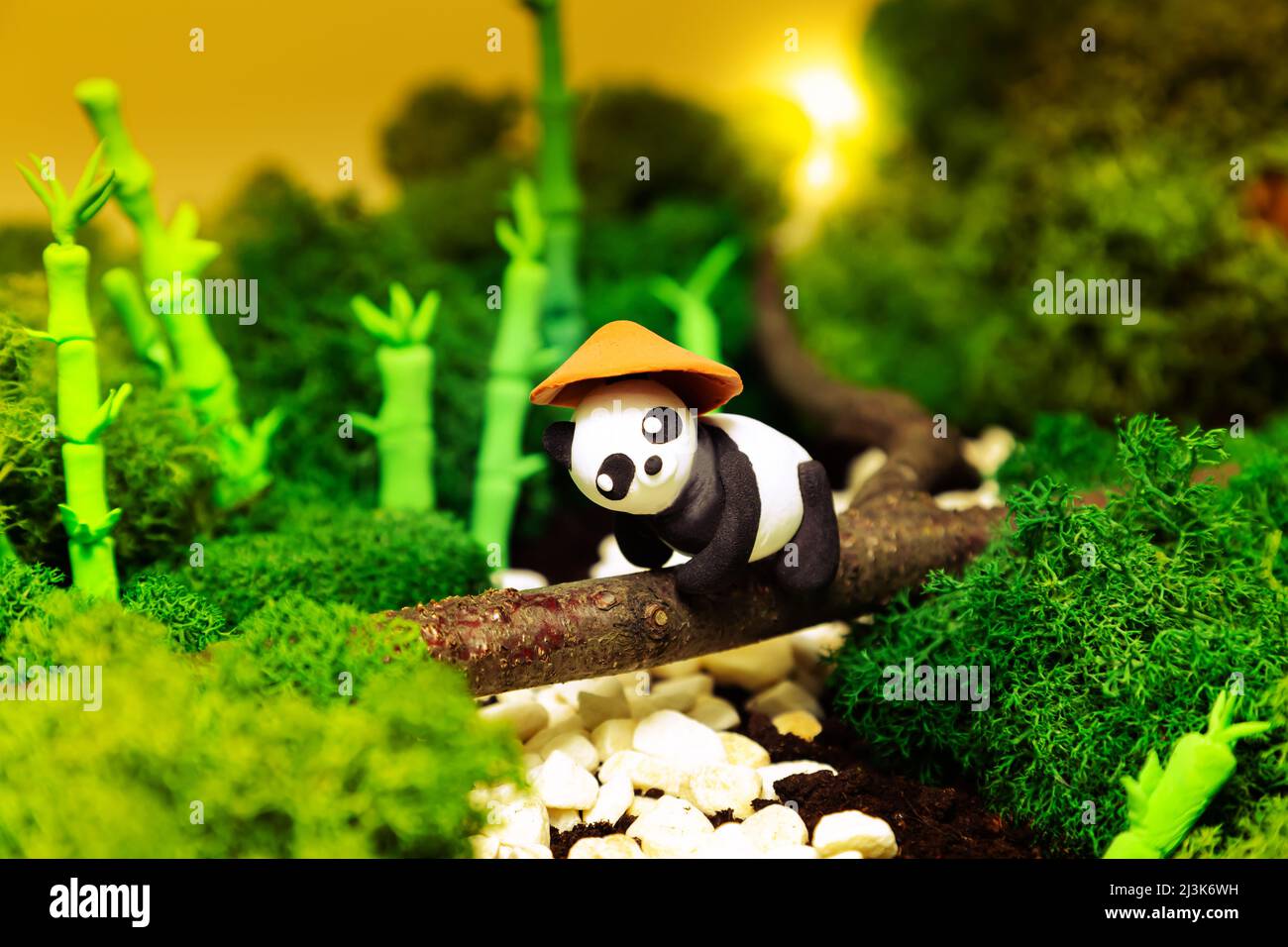 Funny homemade plasticine panda in a stylized jungle. Concept for world ...