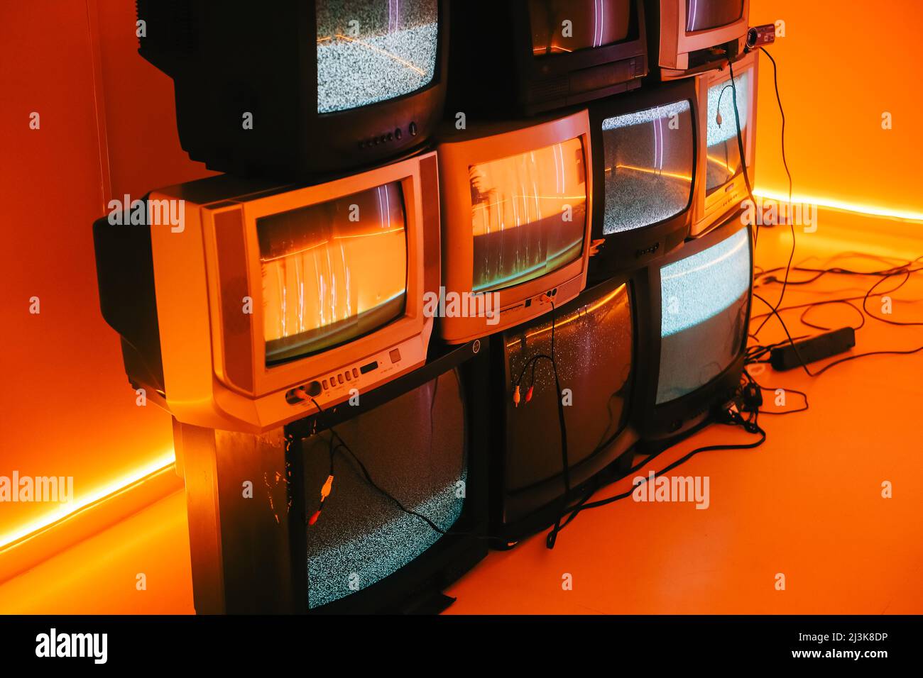 Old vintage tvs on a floor in a room with colored neon light Stock ...