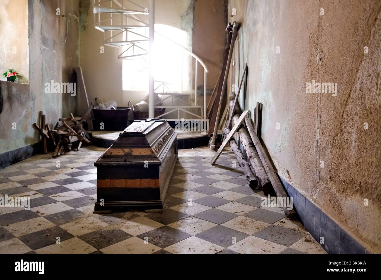 An abandoned wooden coffin rests in a mysterious and luminous old house ...