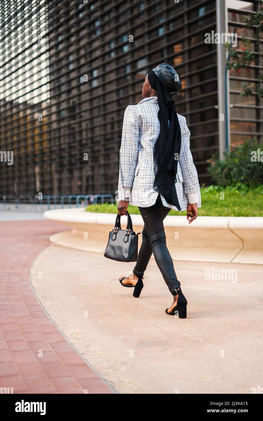 Back view full body of African American female in trendy outfit with ...