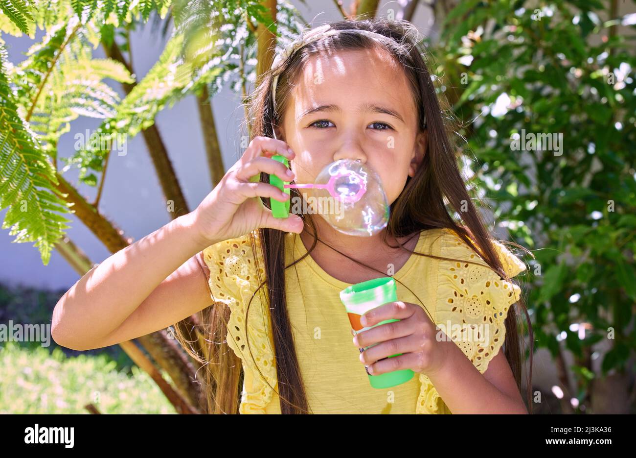My bubbles brings all the fun to the yard. Shot of an adorable little ...