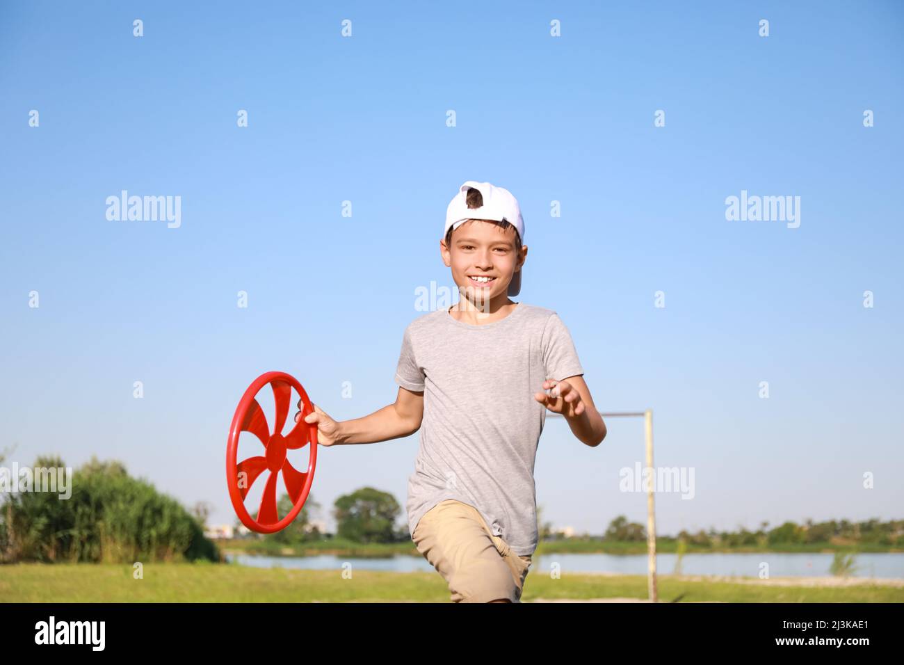 Cute little boy playing frisbee outdoors Stock Photo - Alamy