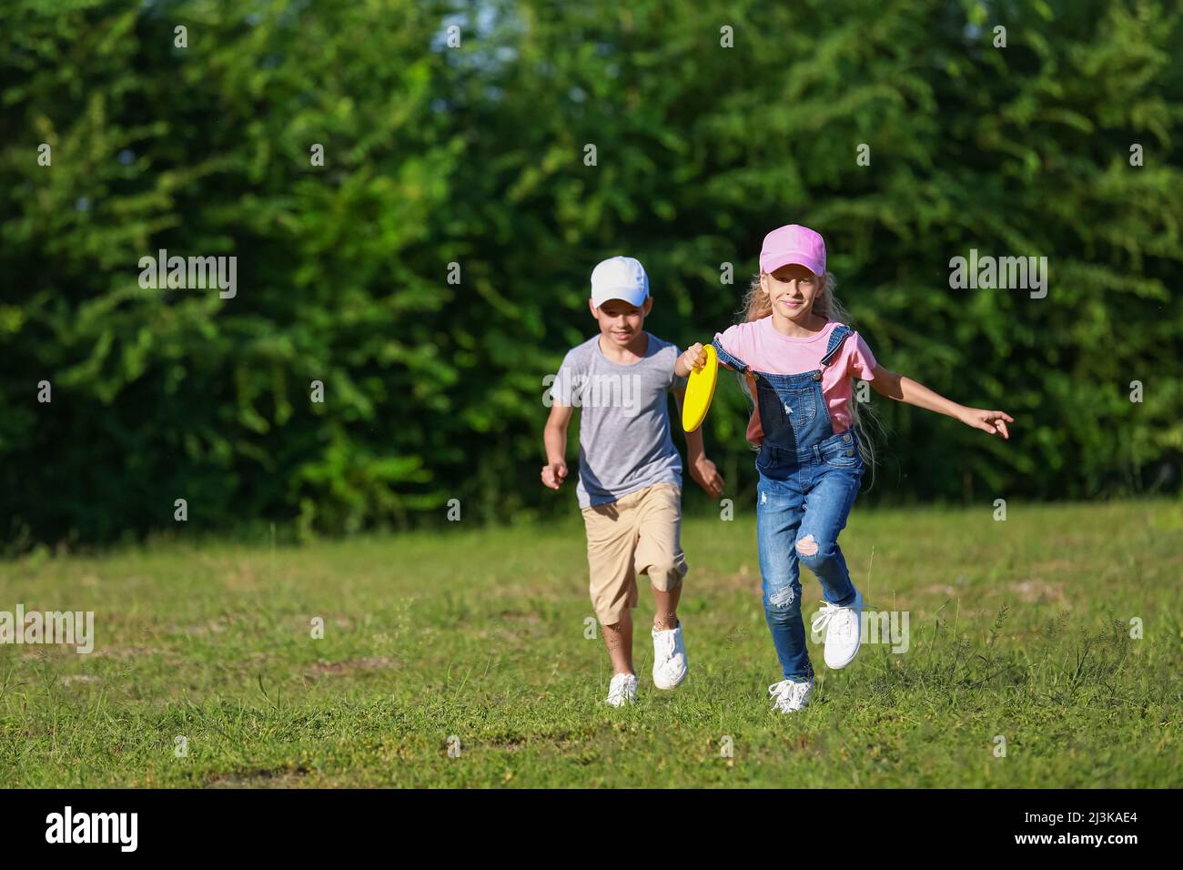 Cute little children playing frisbee outdoors Stock Photo - Alamy