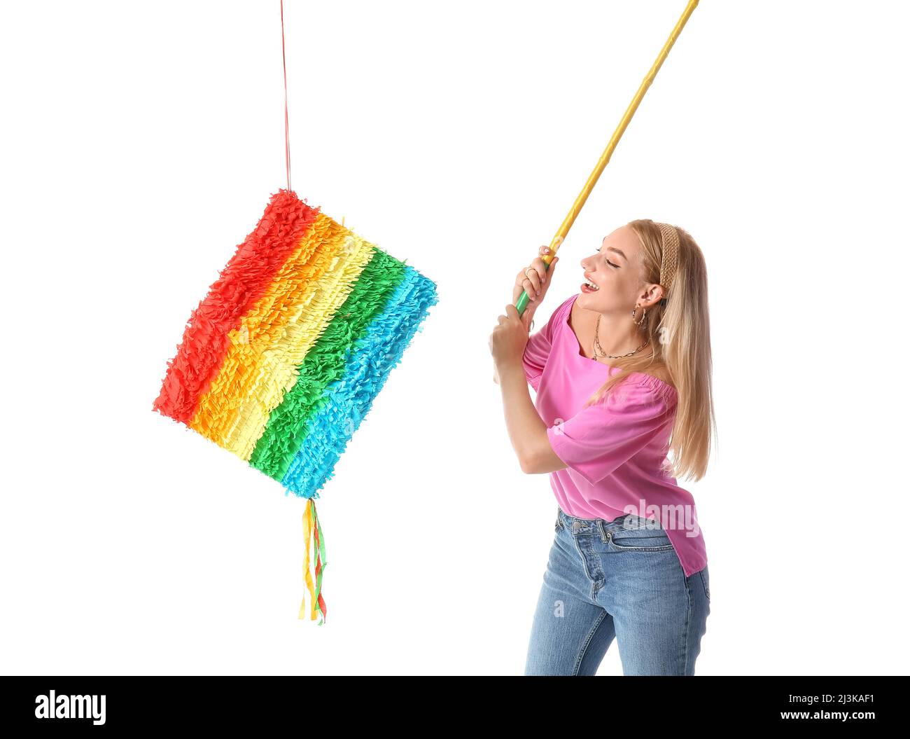 Happy young woman breaking Mexican pinata on white background Stock ...