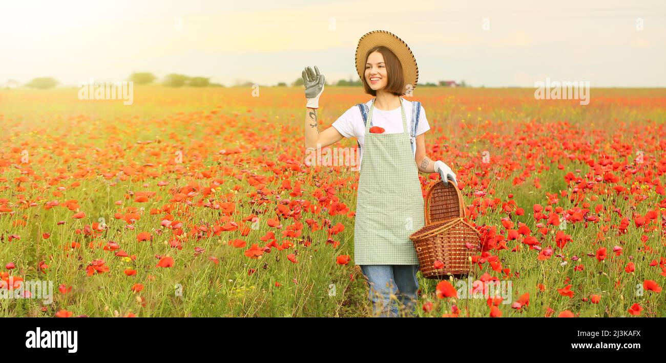 Beautiful female farmer in poppy field Stock Photo - Alamy