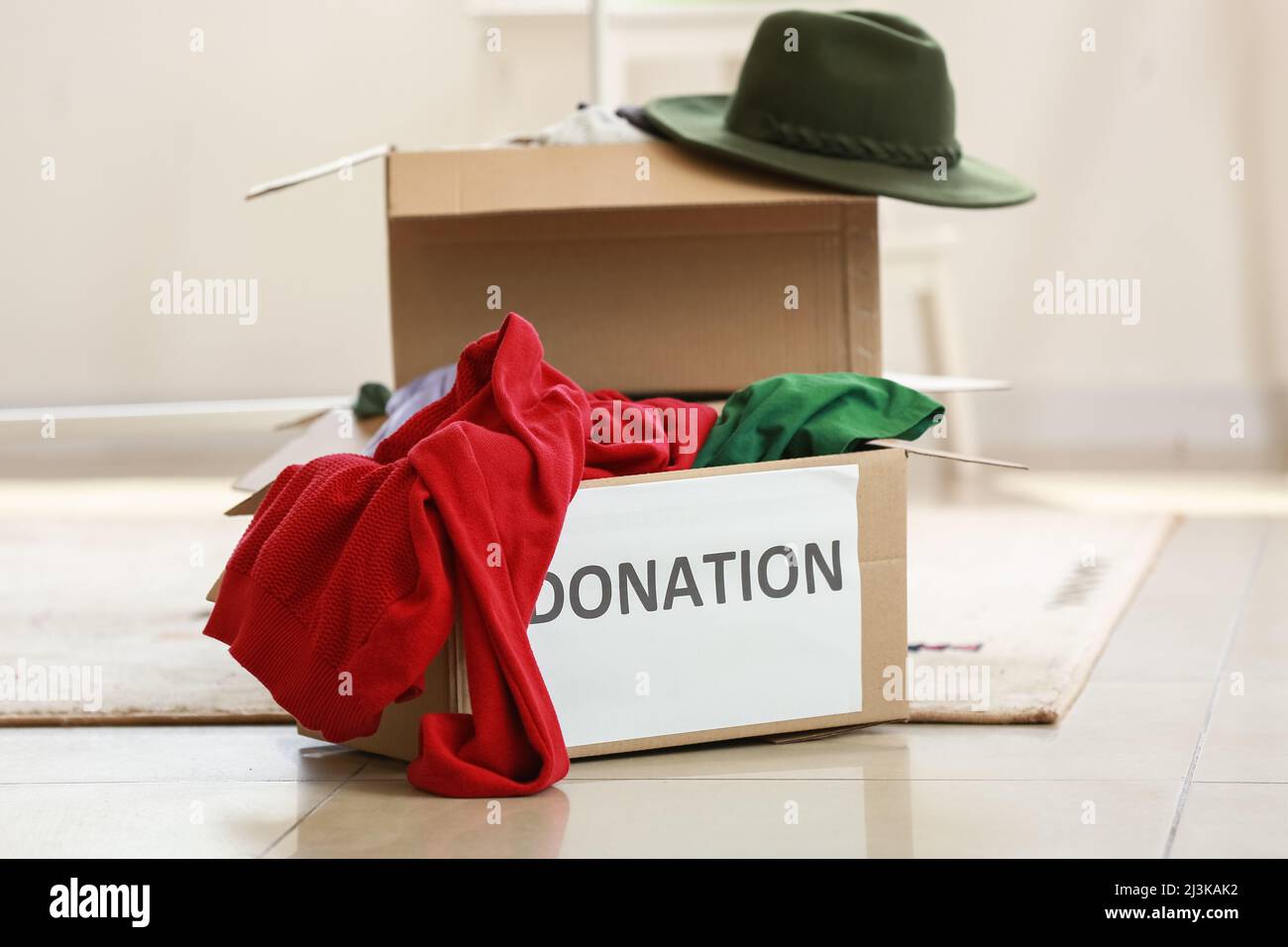 Cardboard boxes with clothes for donation in room Stock Photo - Alamy