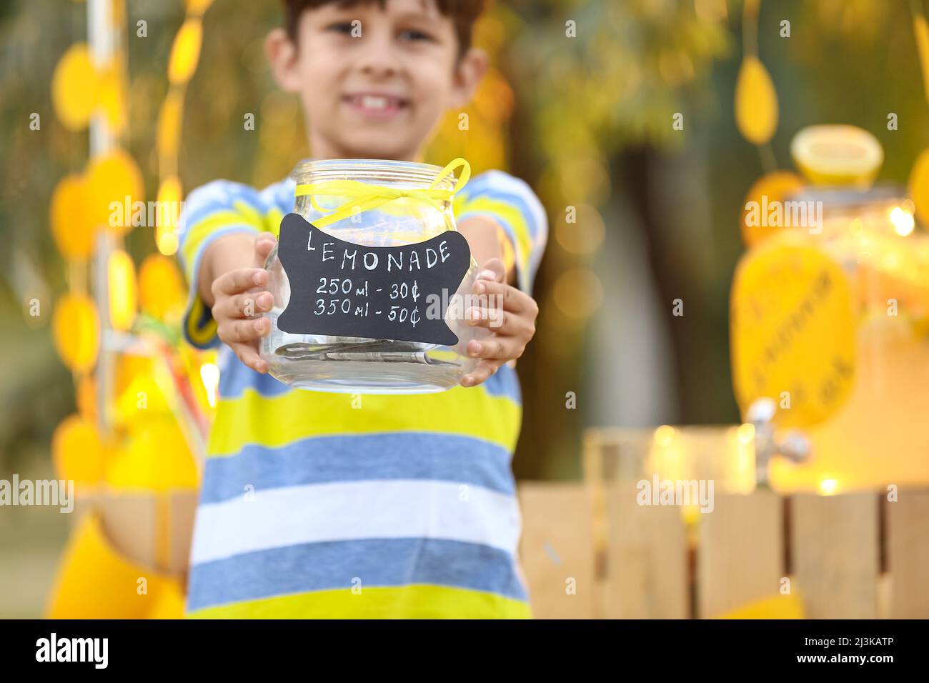 Cute boy selling lemonade in park Stock Photo - Alamy
