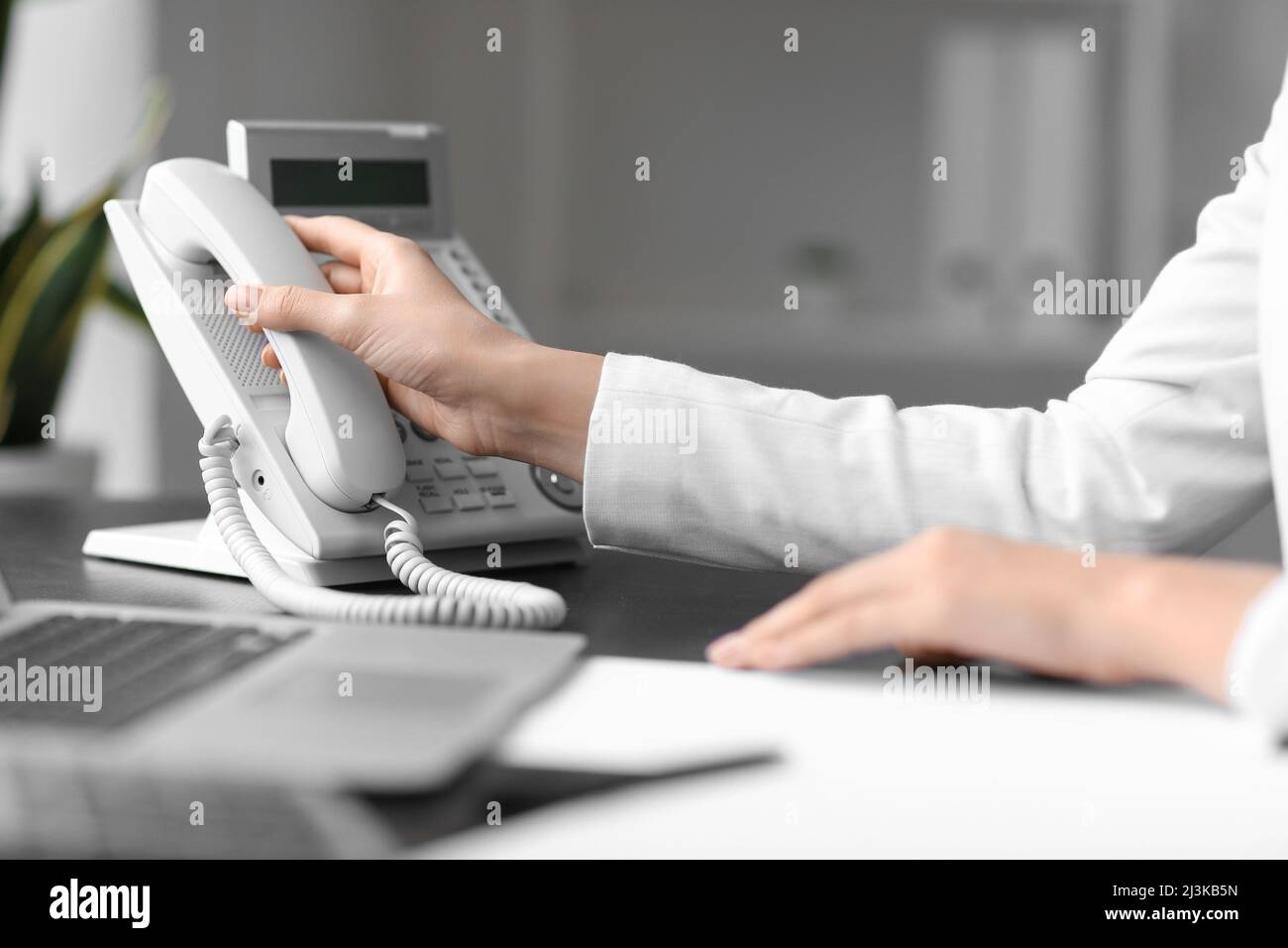 Businesswoman with telephone at table in office, closeup Stock Photo ...