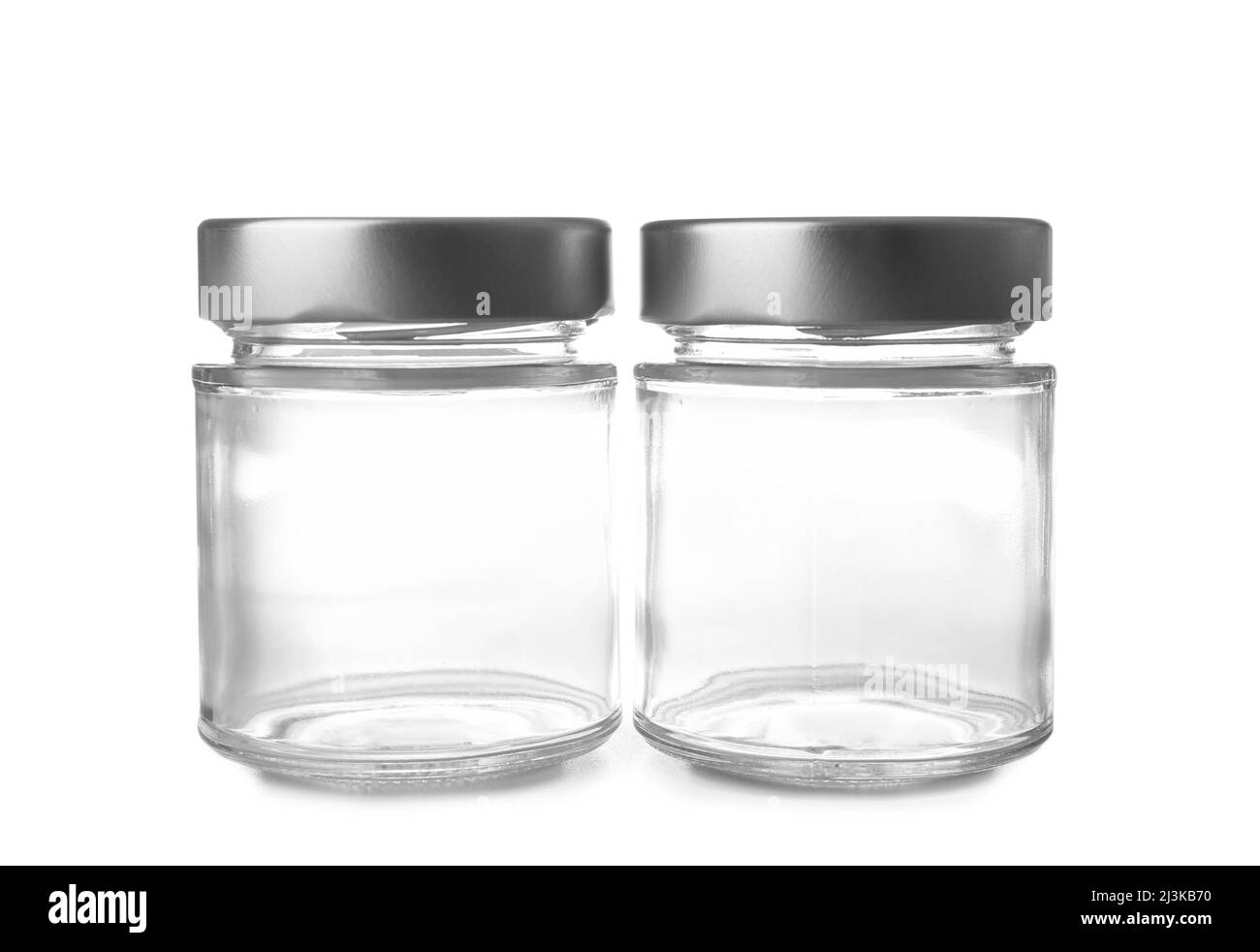 Two glass jars on white background Stock Photo - Alamy