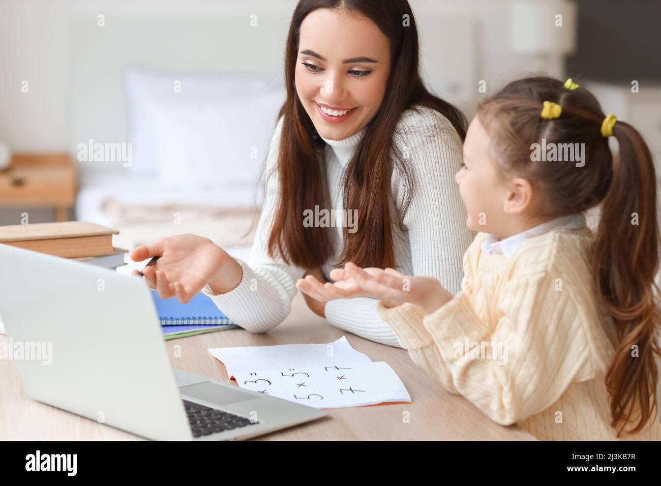 Cute girl studying with tutor at home Stock Photo - Alamy