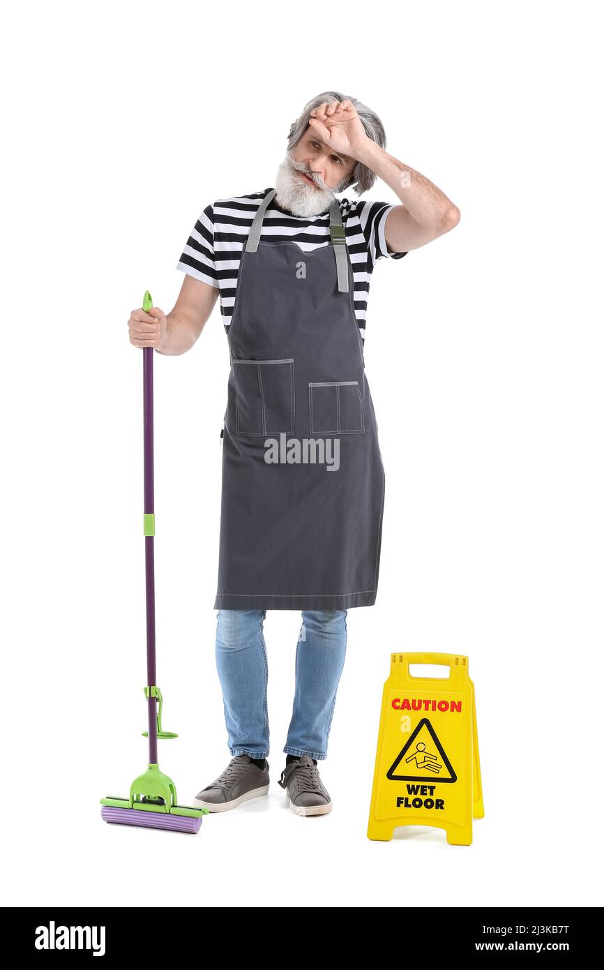 Tired worker of cleaning service with mop and caution sign on white ...