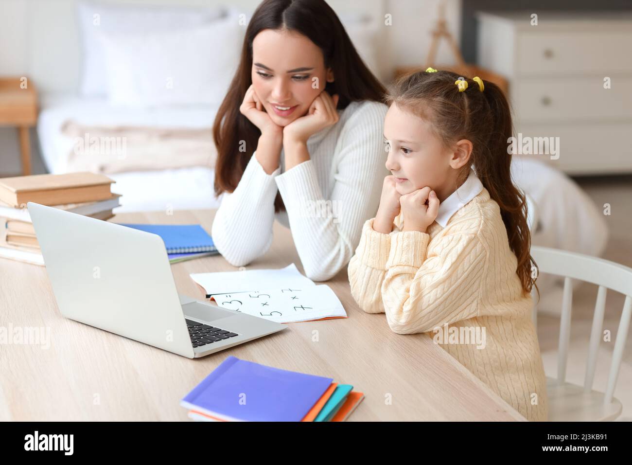 Cute girl studying with tutor at home Stock Photo - Alamy
