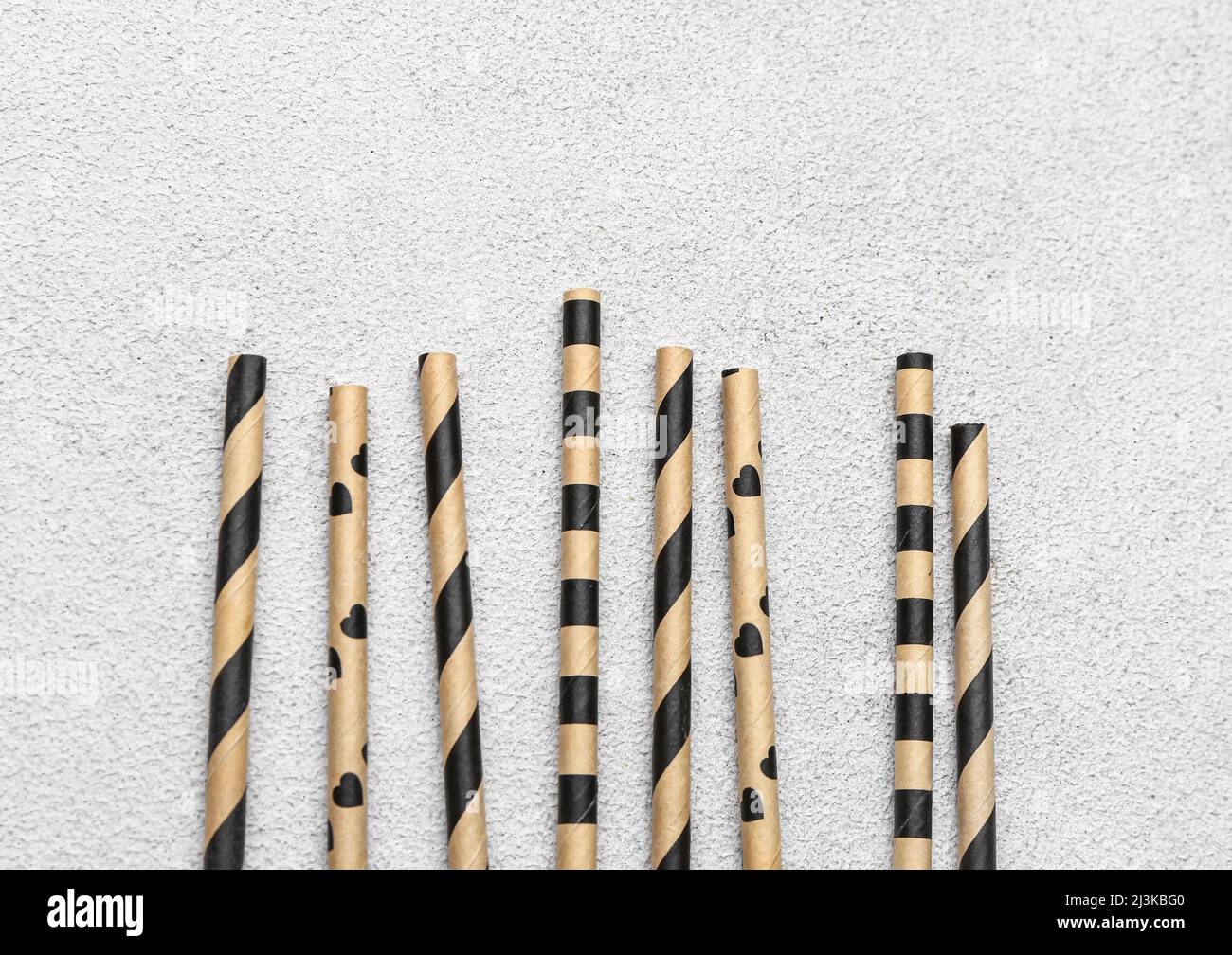 Stylish straws for drinks on grunge background Stock Photo - Alamy