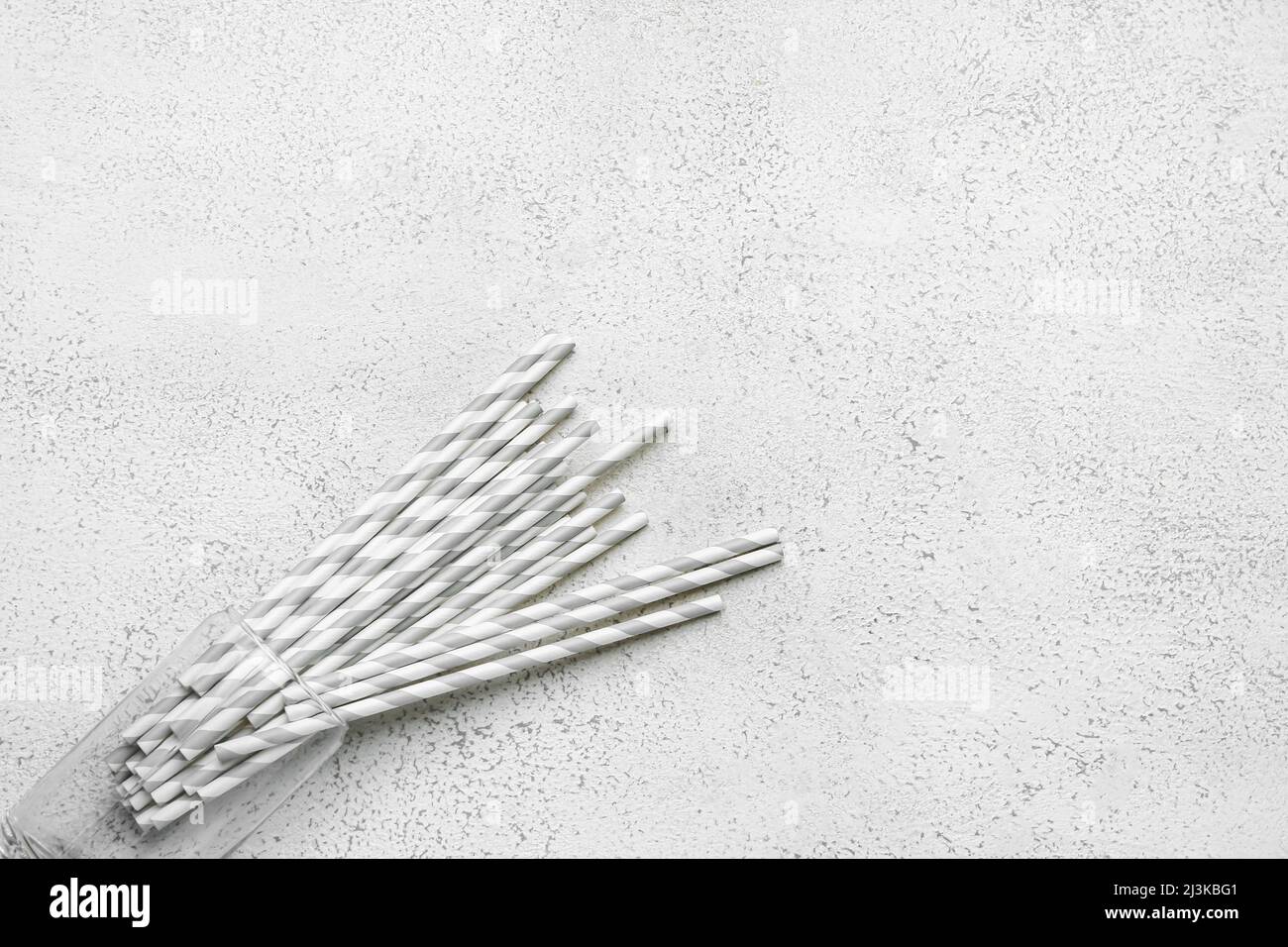 Stylish straws for drinks on grunge background Stock Photo - Alamy