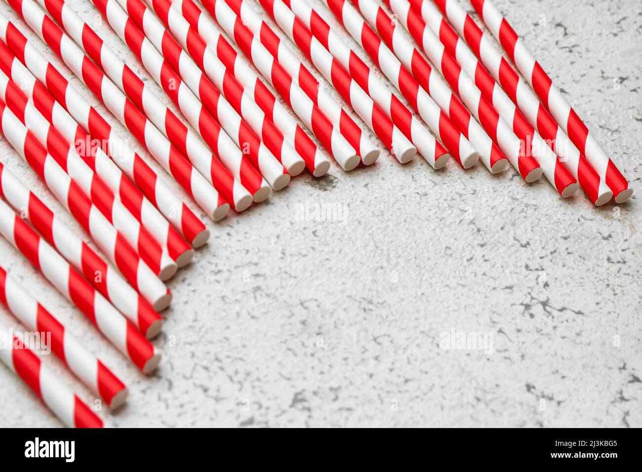Stylish straws for drinks on grunge background Stock Photo - Alamy