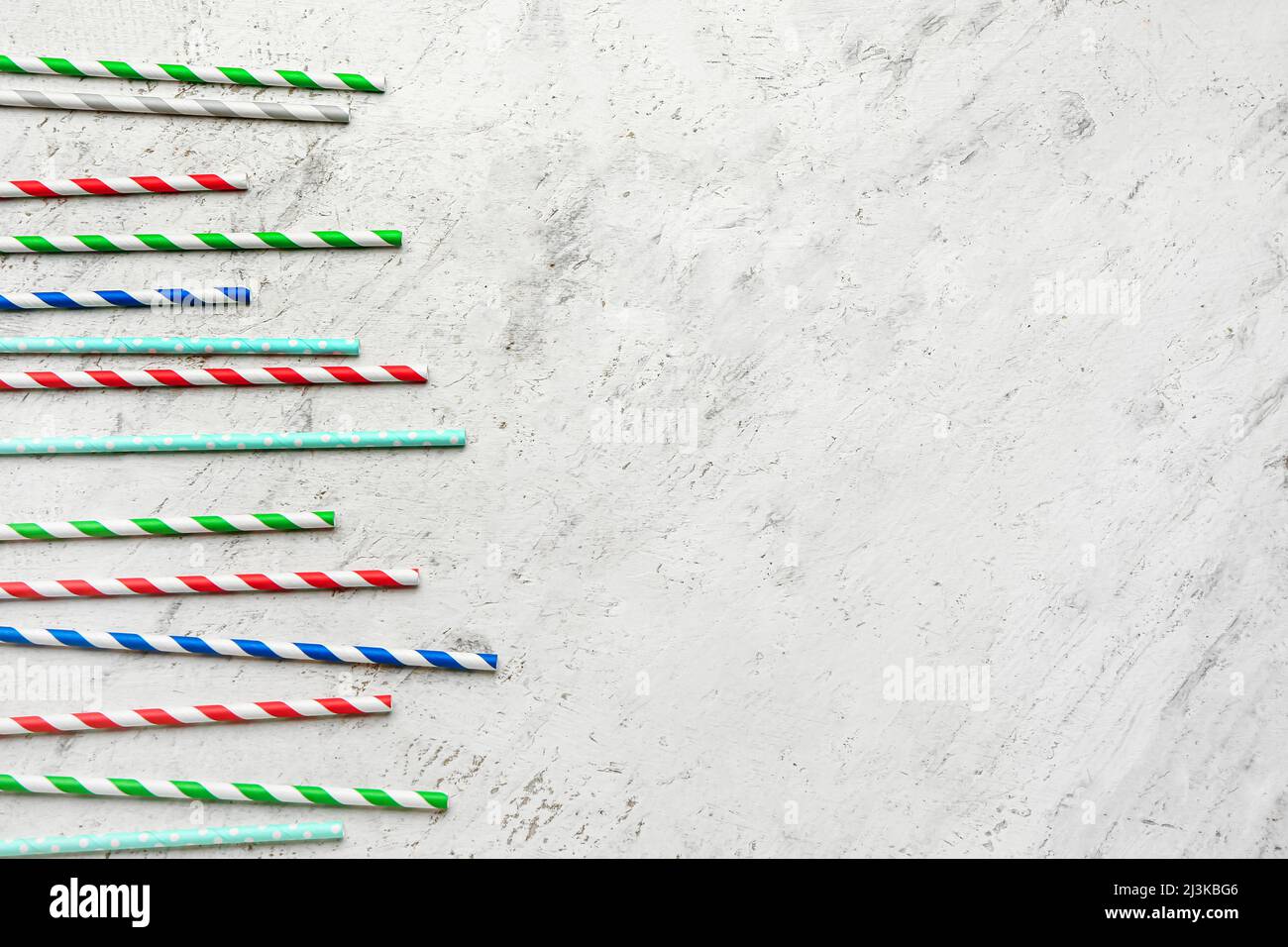 Stylish straws for drinks on grunge background Stock Photo - Alamy