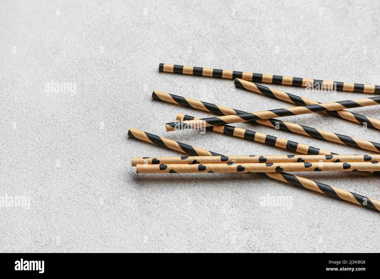 Stylish straws for drinks on grunge background Stock Photo - Alamy