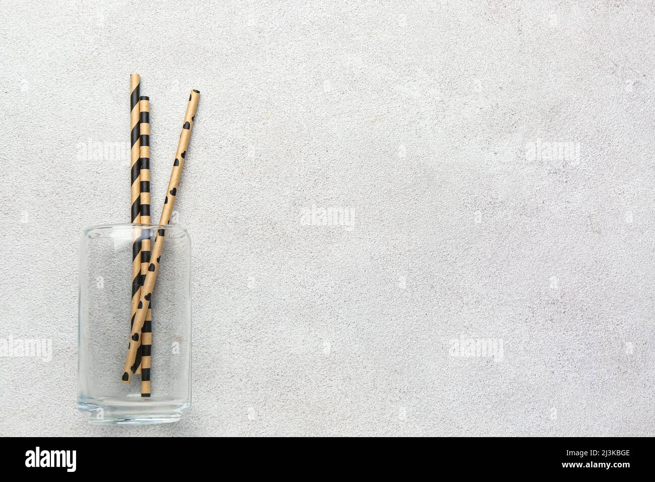 Glass with stylish straws for drinks on grunge background Stock Photo ...
