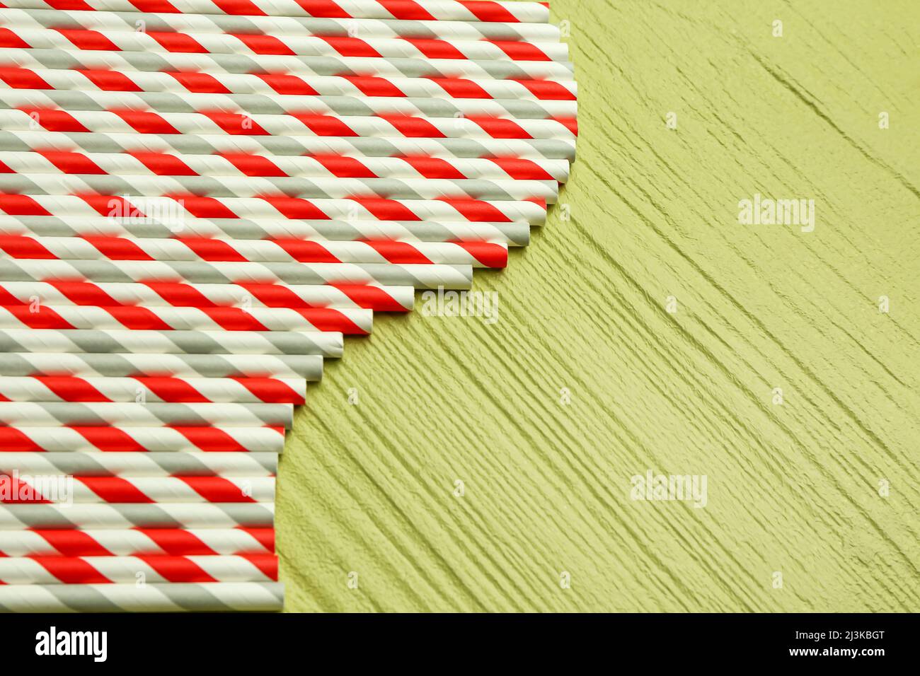 Stylish straws for drinks on green wooden background Stock Photo - Alamy