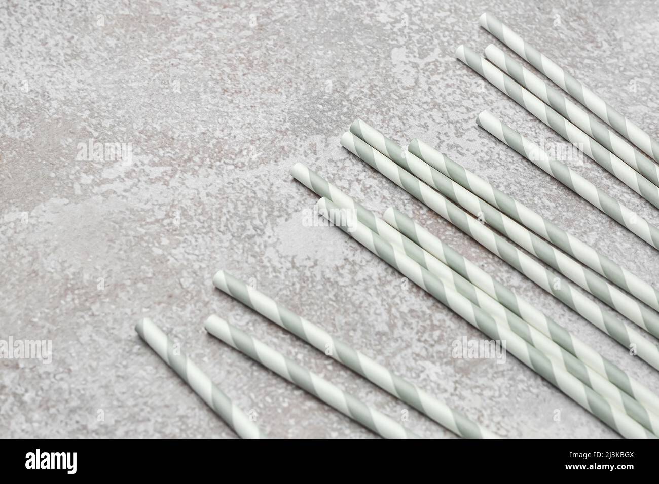 Stylish straws for drinks on grunge background Stock Photo - Alamy