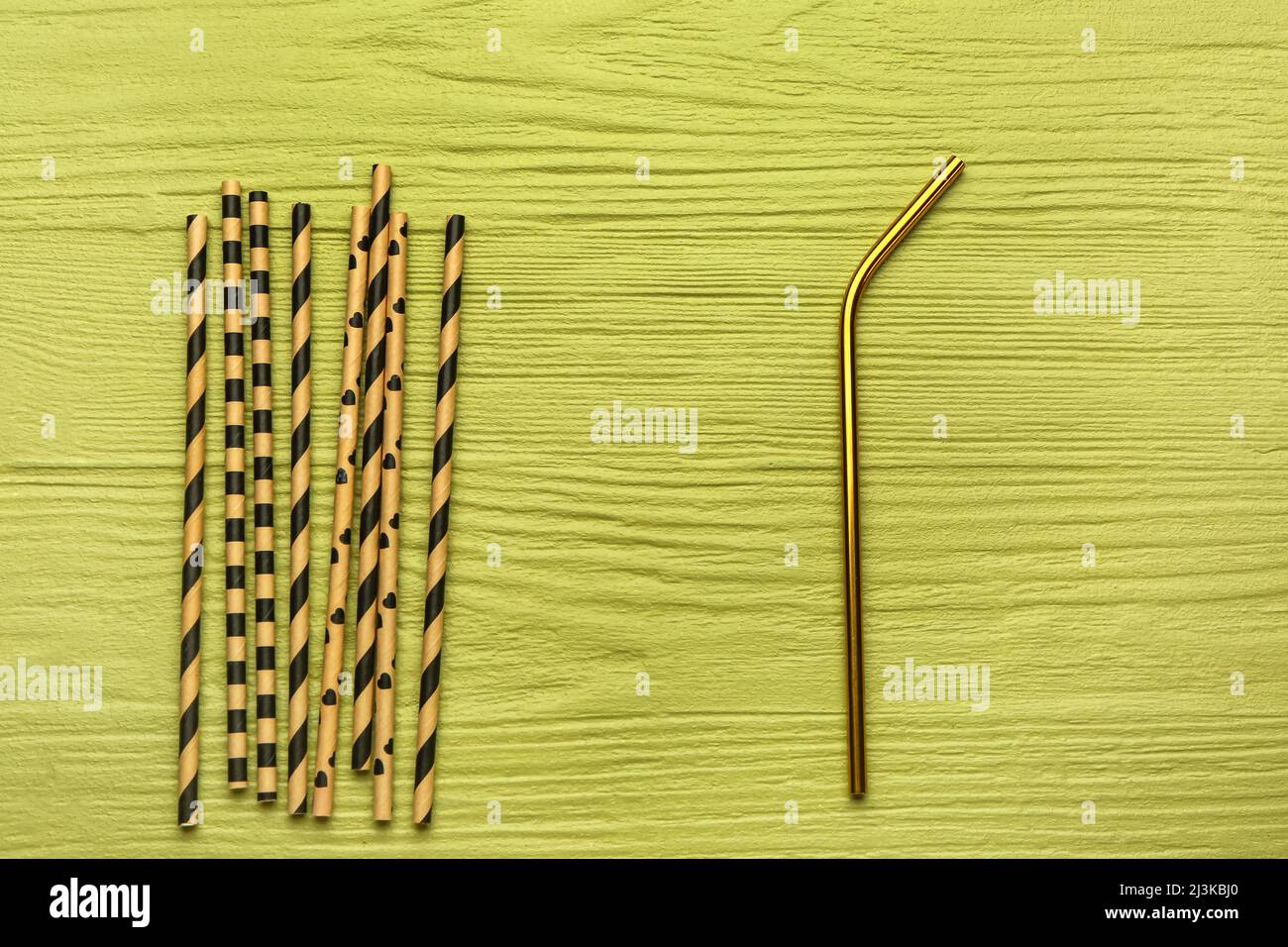 Stylish straws for drinks on green wooden background. Concept of ...