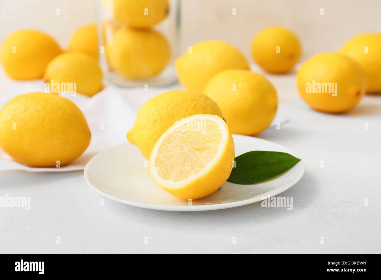 Many fresh lemons on light table Stock Photo - Alamy