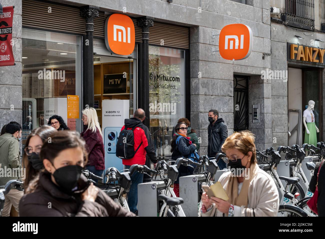 Pedestrians walk past the Chinese multinational technology and ...