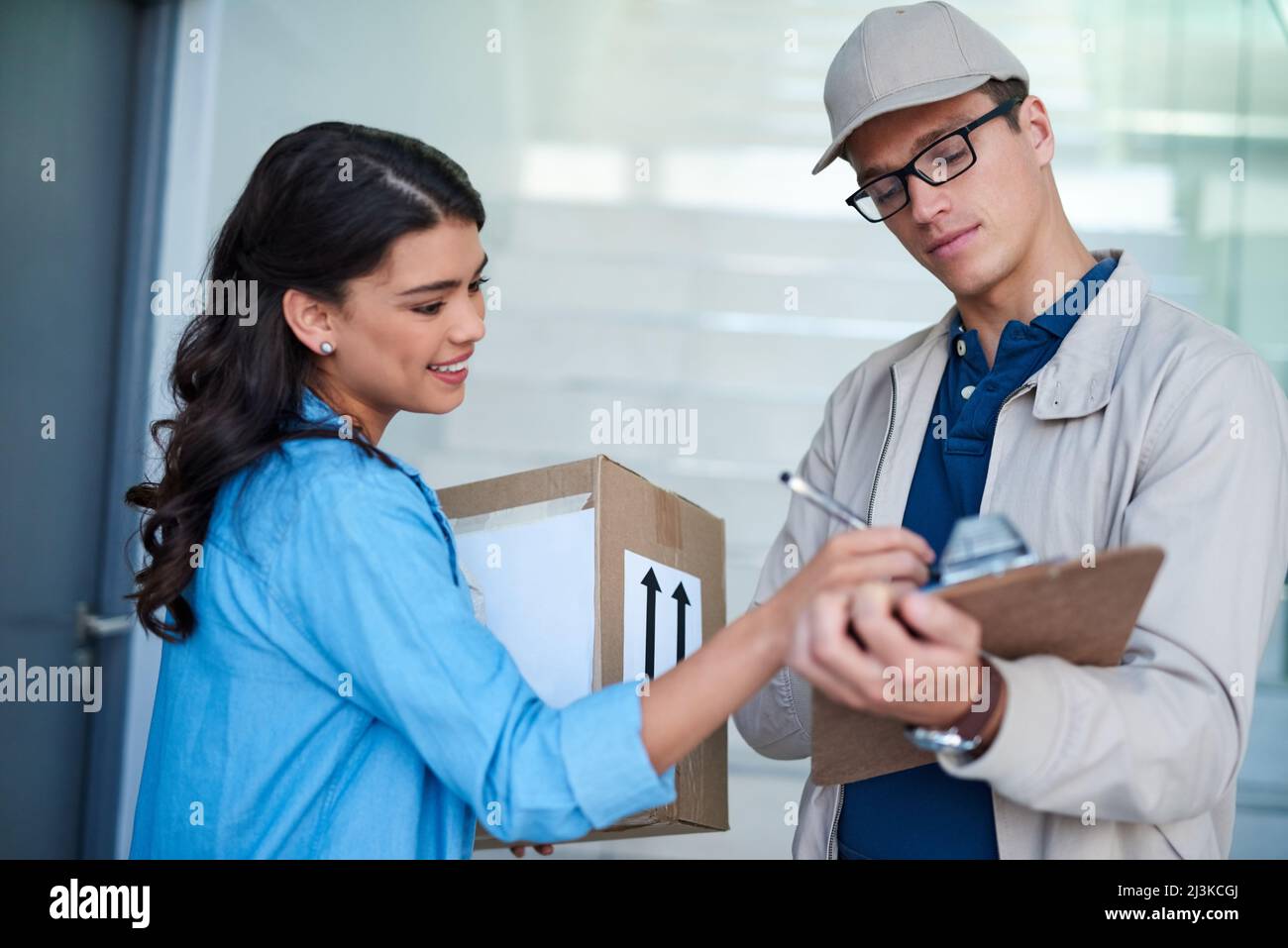 Thank you for such a swift service. Shot of a young woman signing for a ...