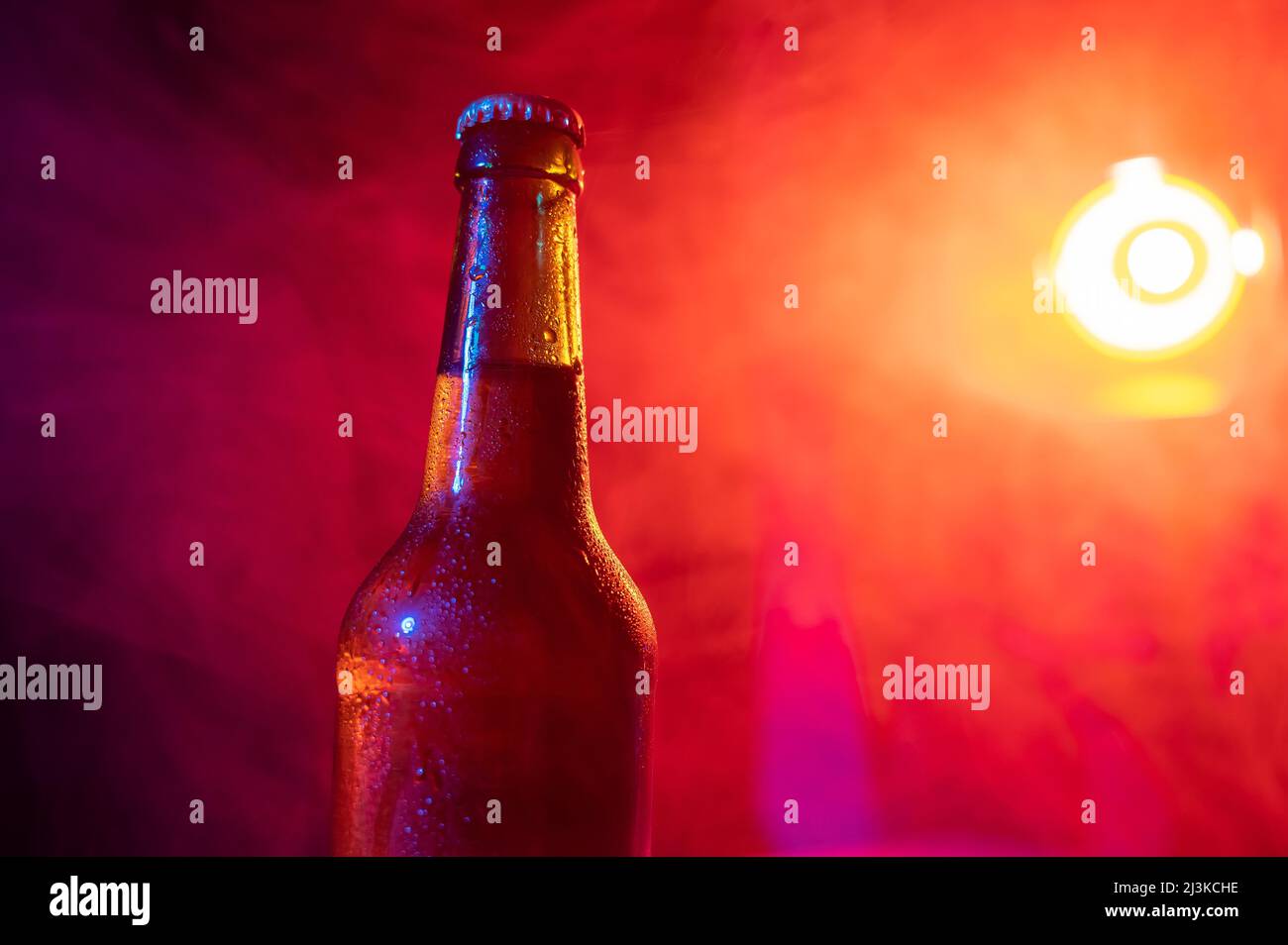 Glass bottle of beer in blue pink mist Stock Photo - Alamy