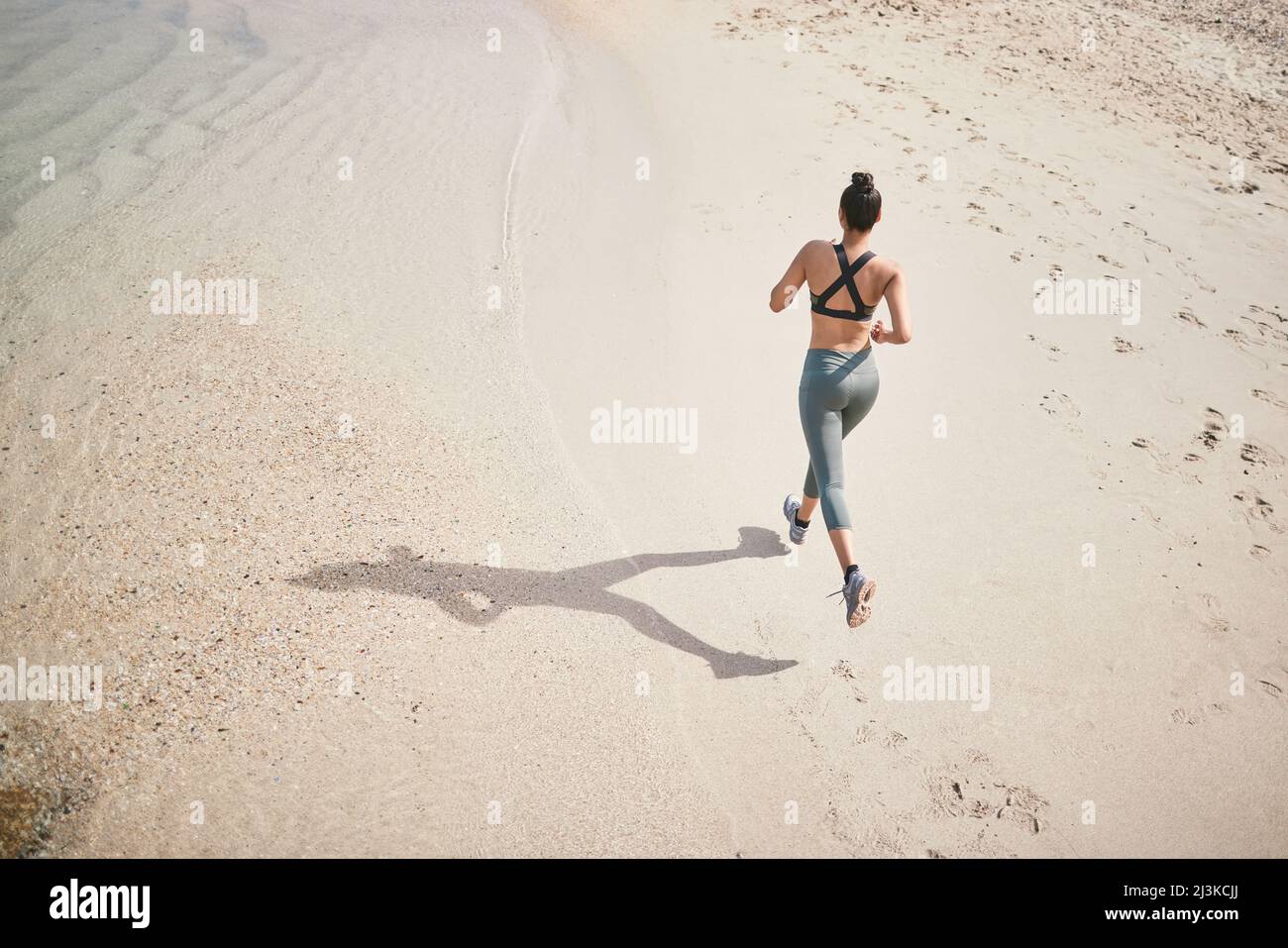Making tracks. High angle shot of an unrecognizable athletic young ...
