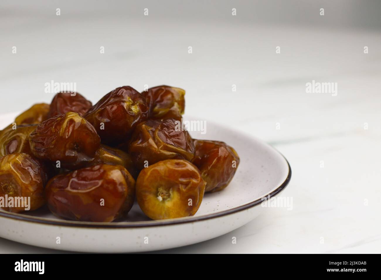 Kurma Sukkari or Sukkari Dates on marble white background. Breakfasting ...