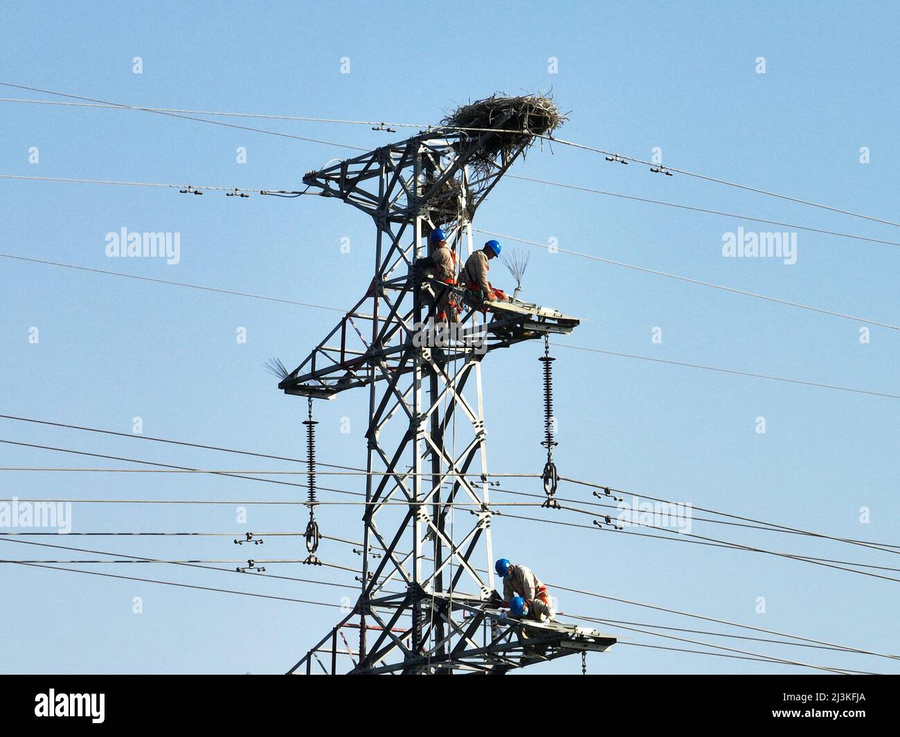 SUQIAN, CHINA - APRIL 8, 2022 - A power supply worker installs a bird ...