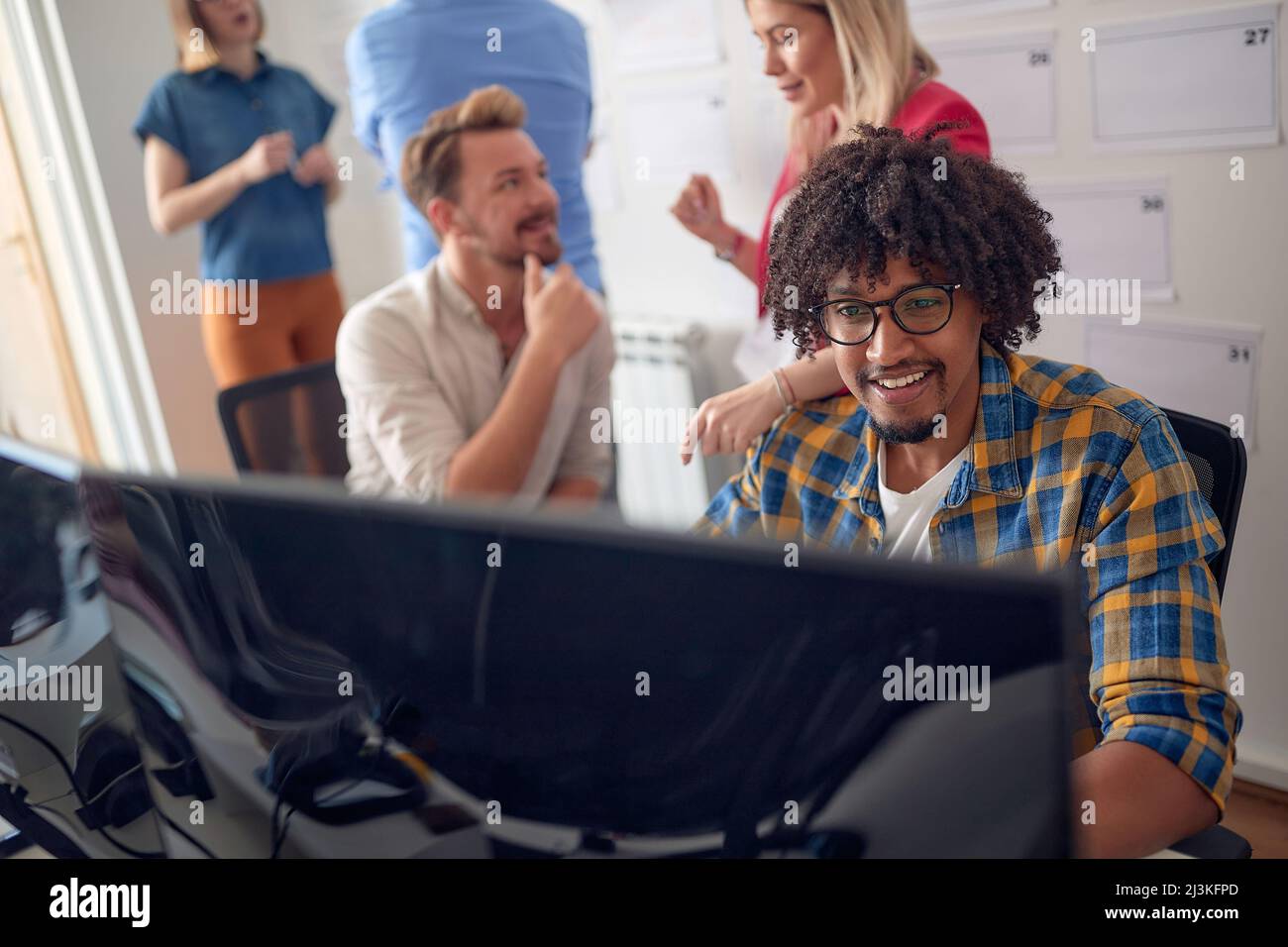 Group young coworkers discussing project hi-res stock photography and ...