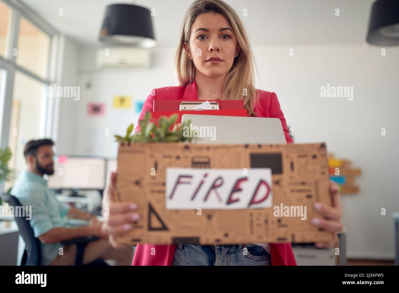 Close-up of a young sad female office employee posing for a photo after ...