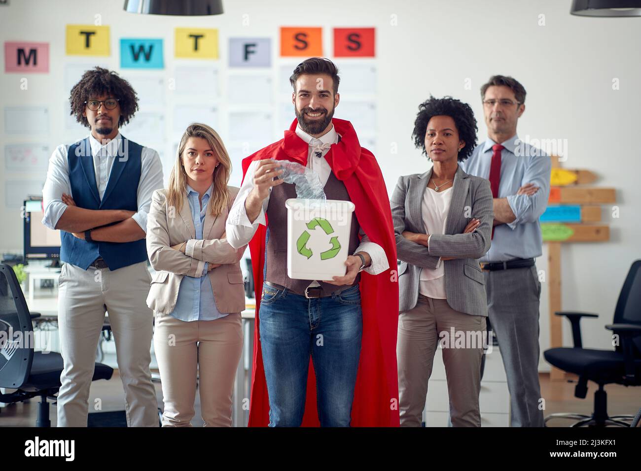 A group of employees in a pleasant atmosphere in the office is posing ...
