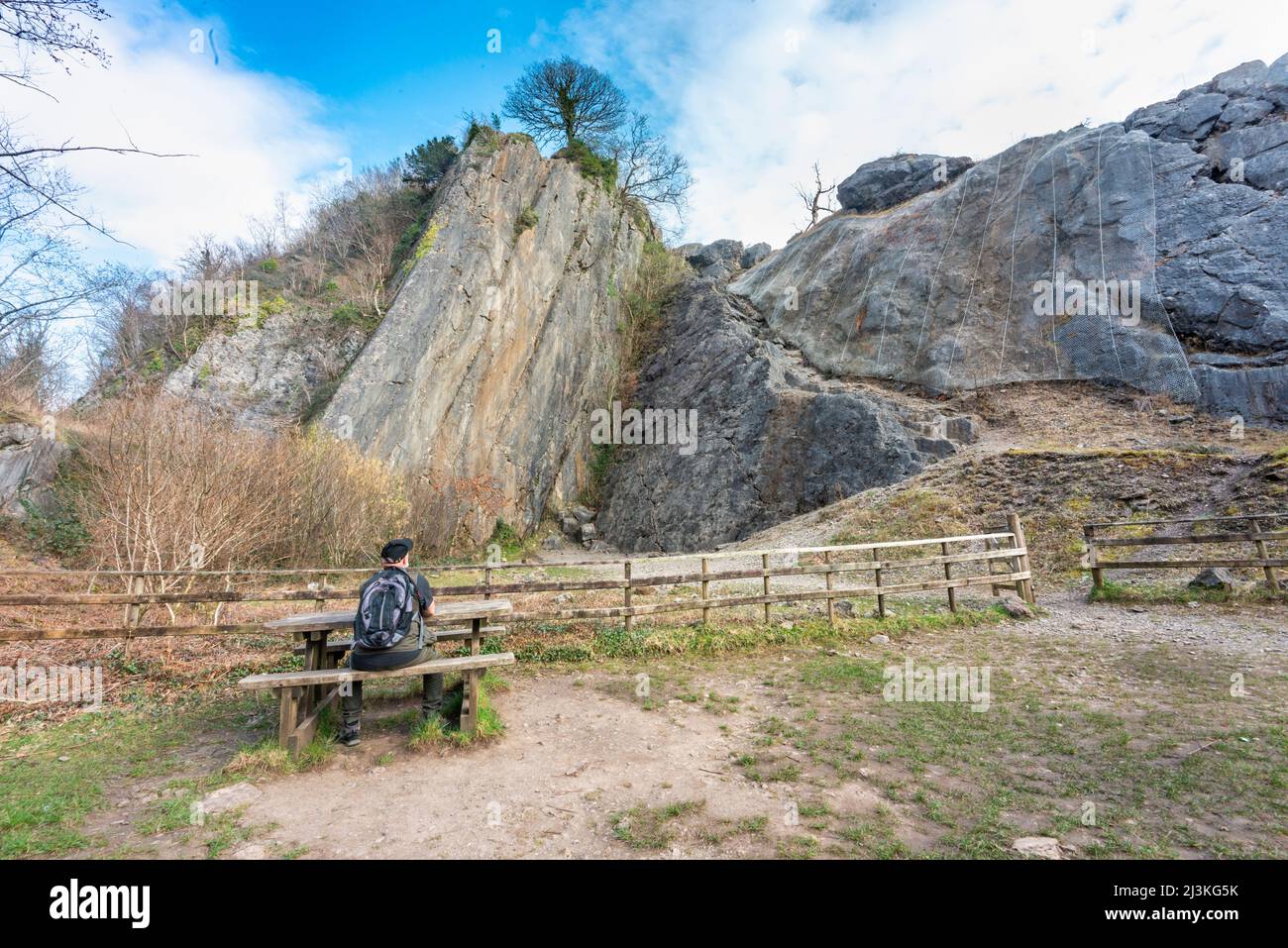 Seating area,near the large impressive high limestone rock and cliff ...