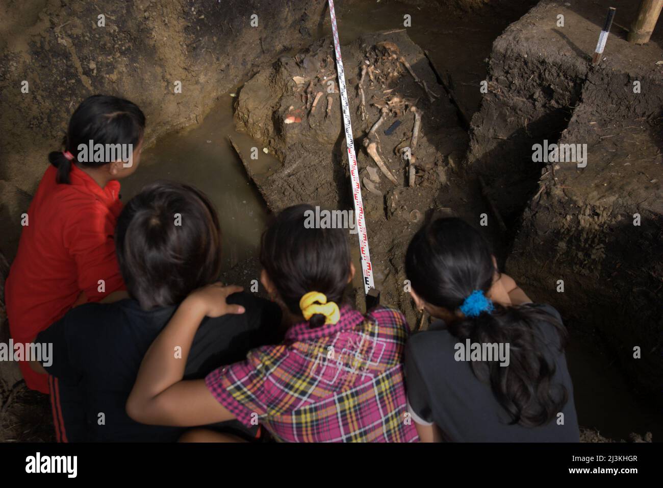 Villagers paying attention to the excavation site of prehistoric burial ...