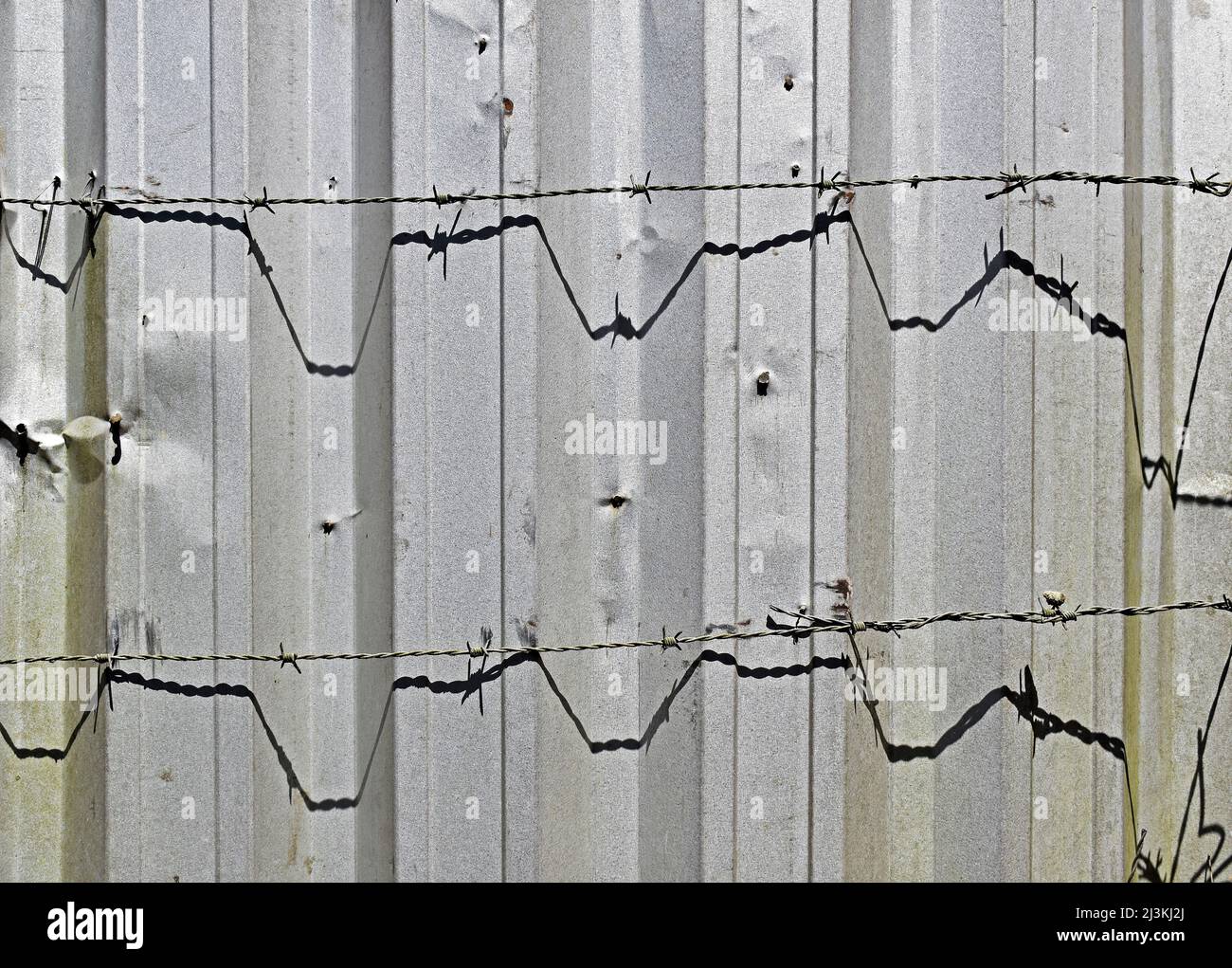 Metallic surface and barbed wire Stock Photo - Alamy