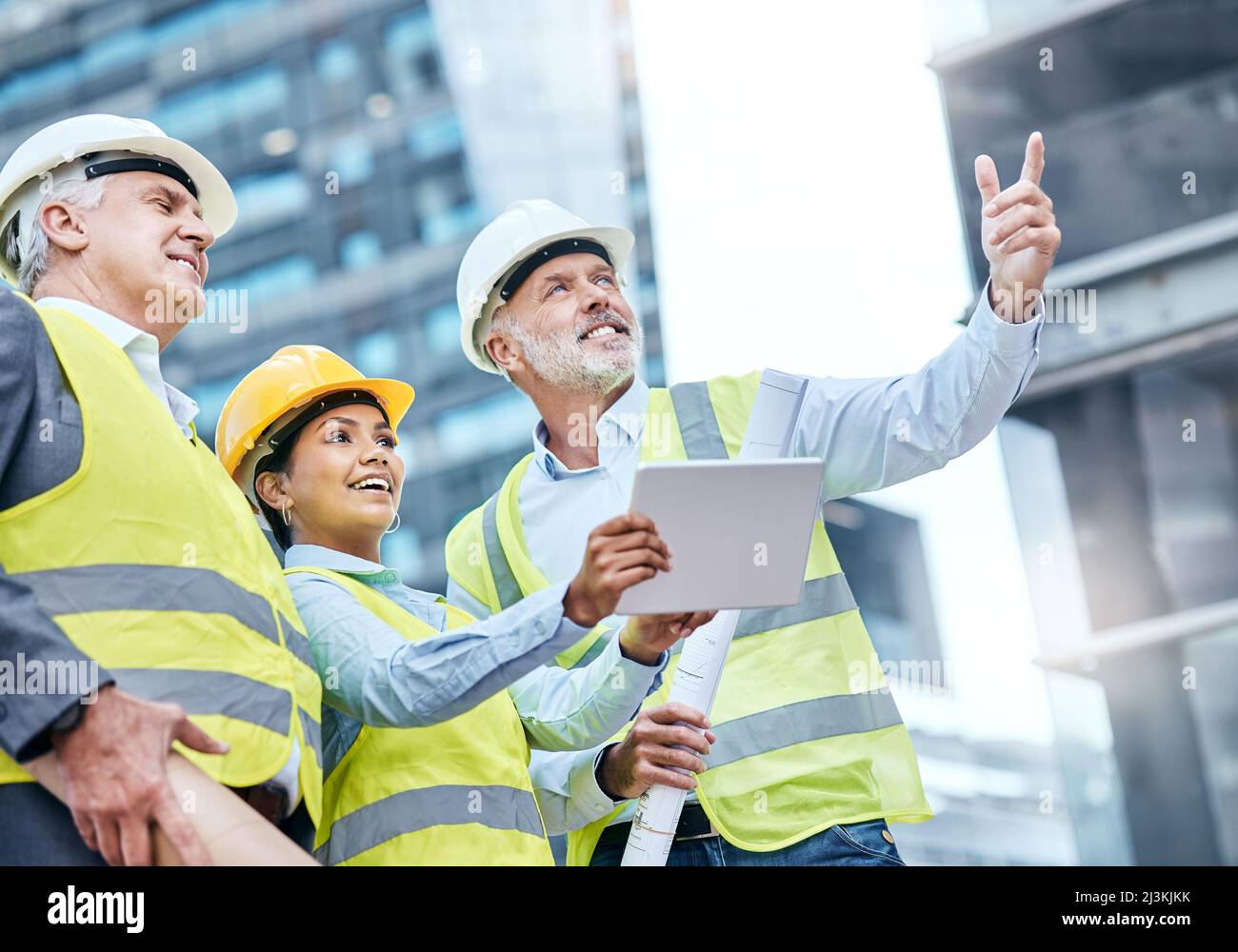 Managing a complex project together. Shot of a group of businesspeople ...