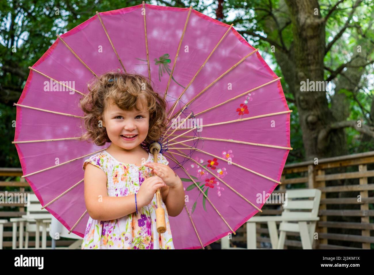 Girl holding parasol hi-res stock photography and images - Alamy