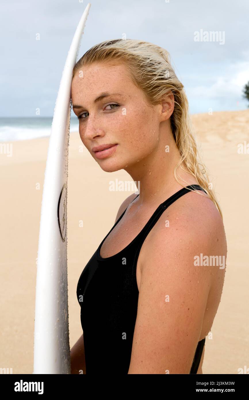Portrait of a professional surfer with surfboard on a beach Stock Photo ...