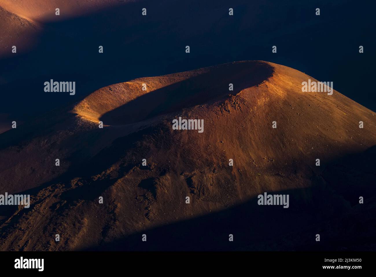 Sunlit rim of the Haleakala Crater at sunset; Kula, Maui, Hawaii ...