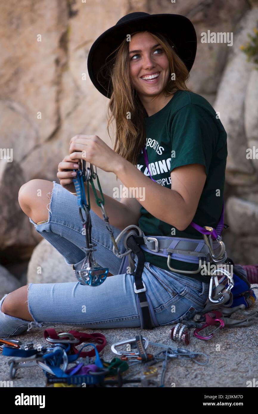 A young woman racks up for a climb in Joshua National Park Stock Photo ...