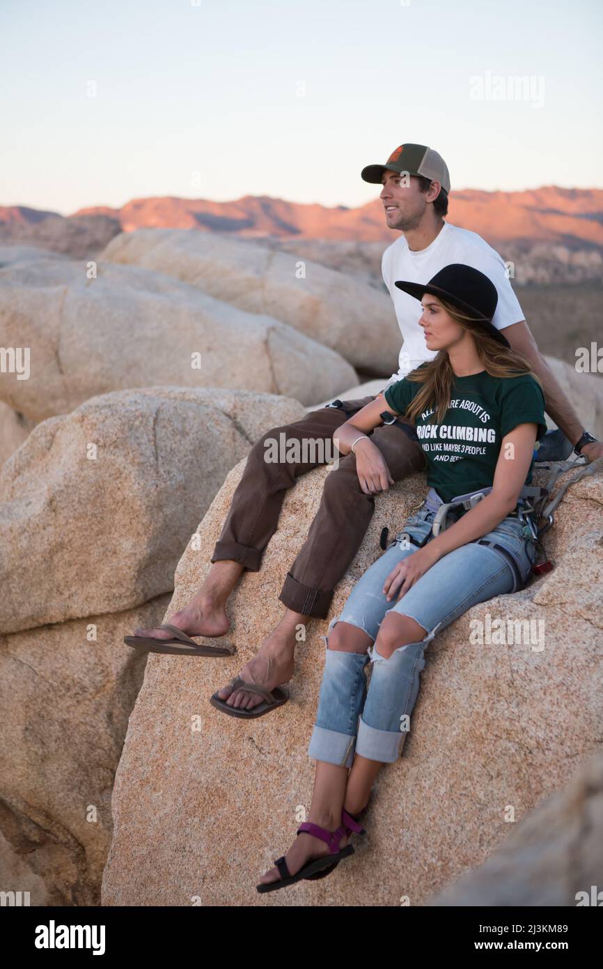 A young couple take in the sunset after climbing The Eye route on ...