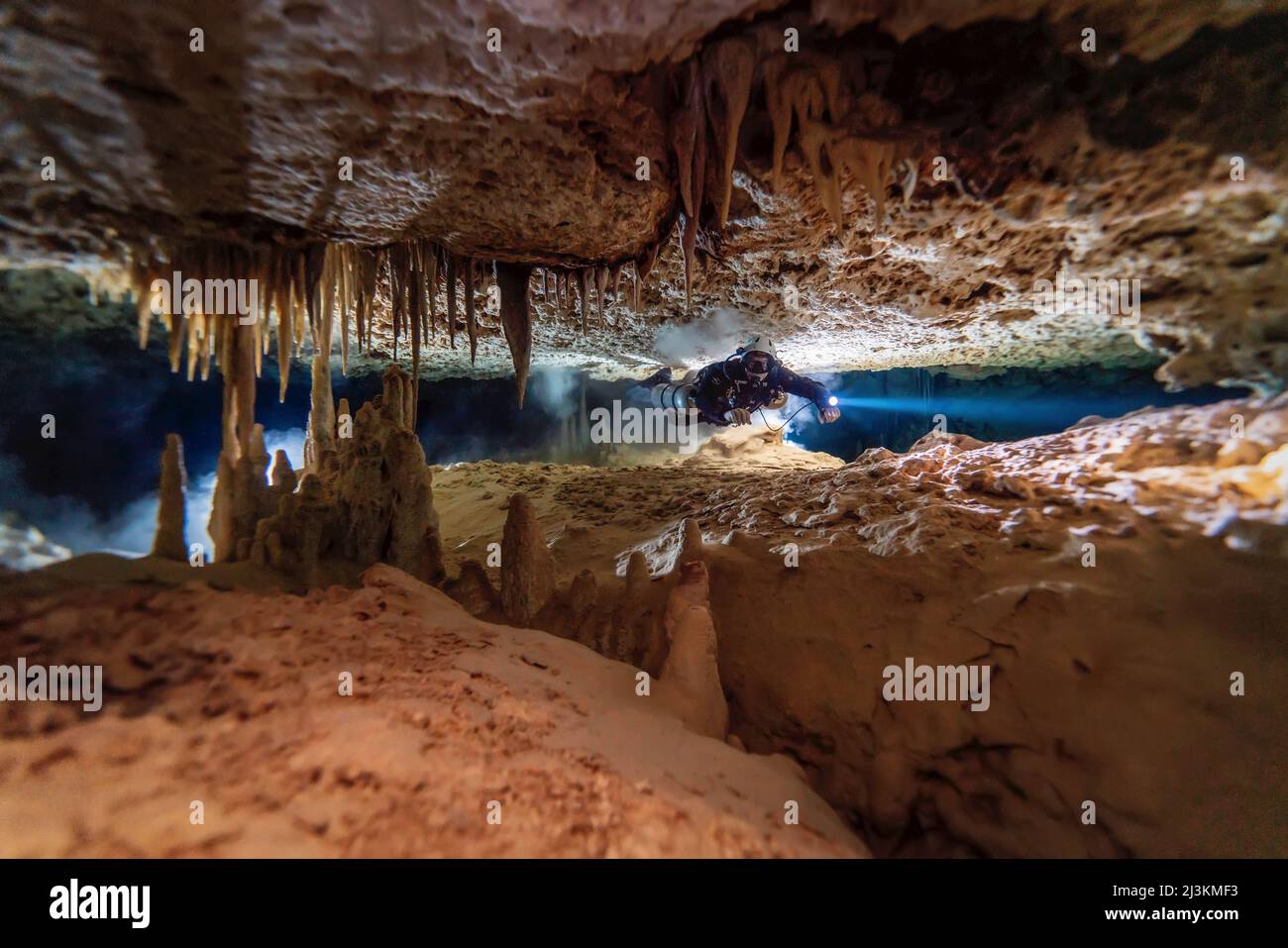 A cave diver passes through a restriction Stock Photo - Alamy