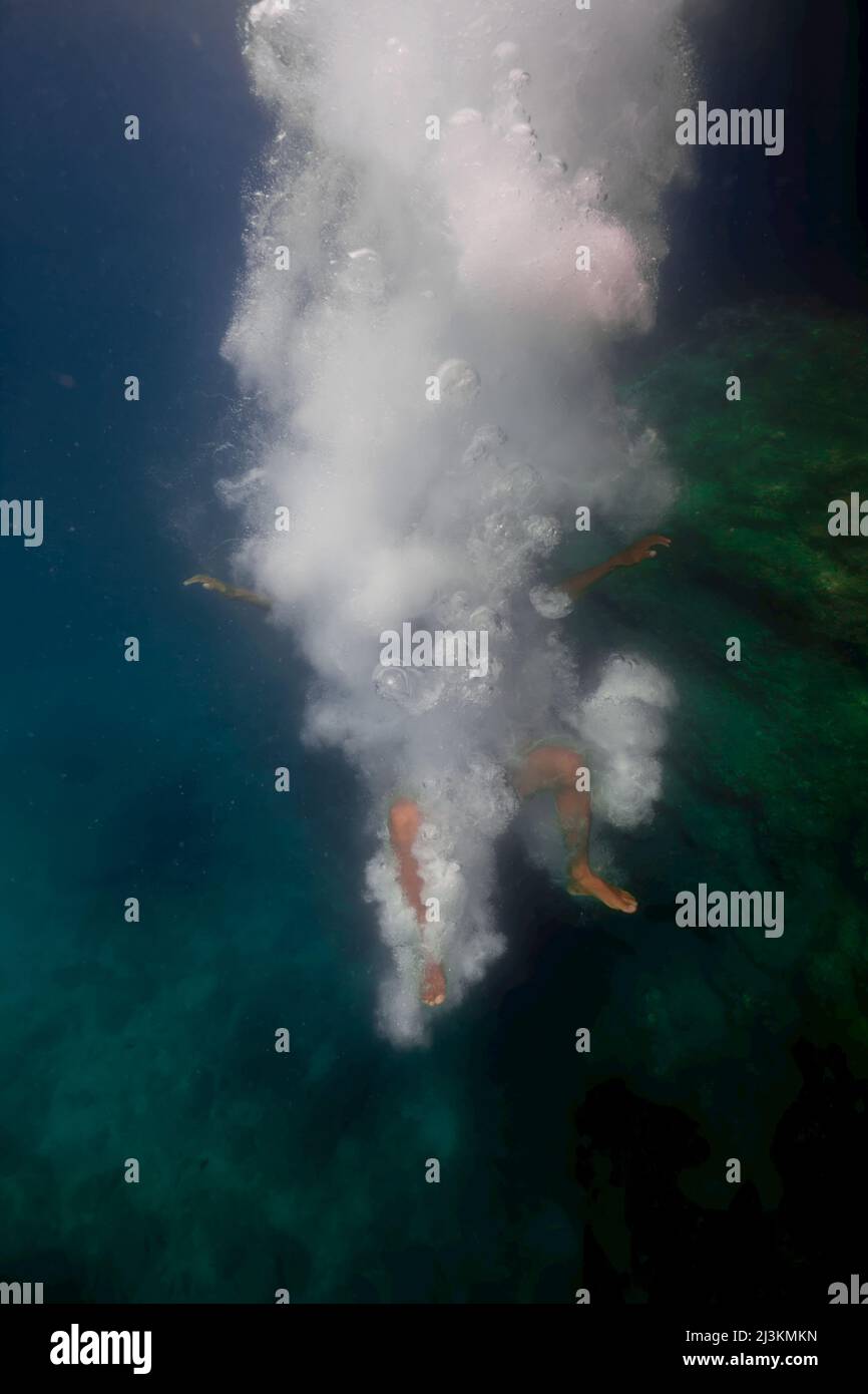 A climber launched himself from the cliff into the water below after ...