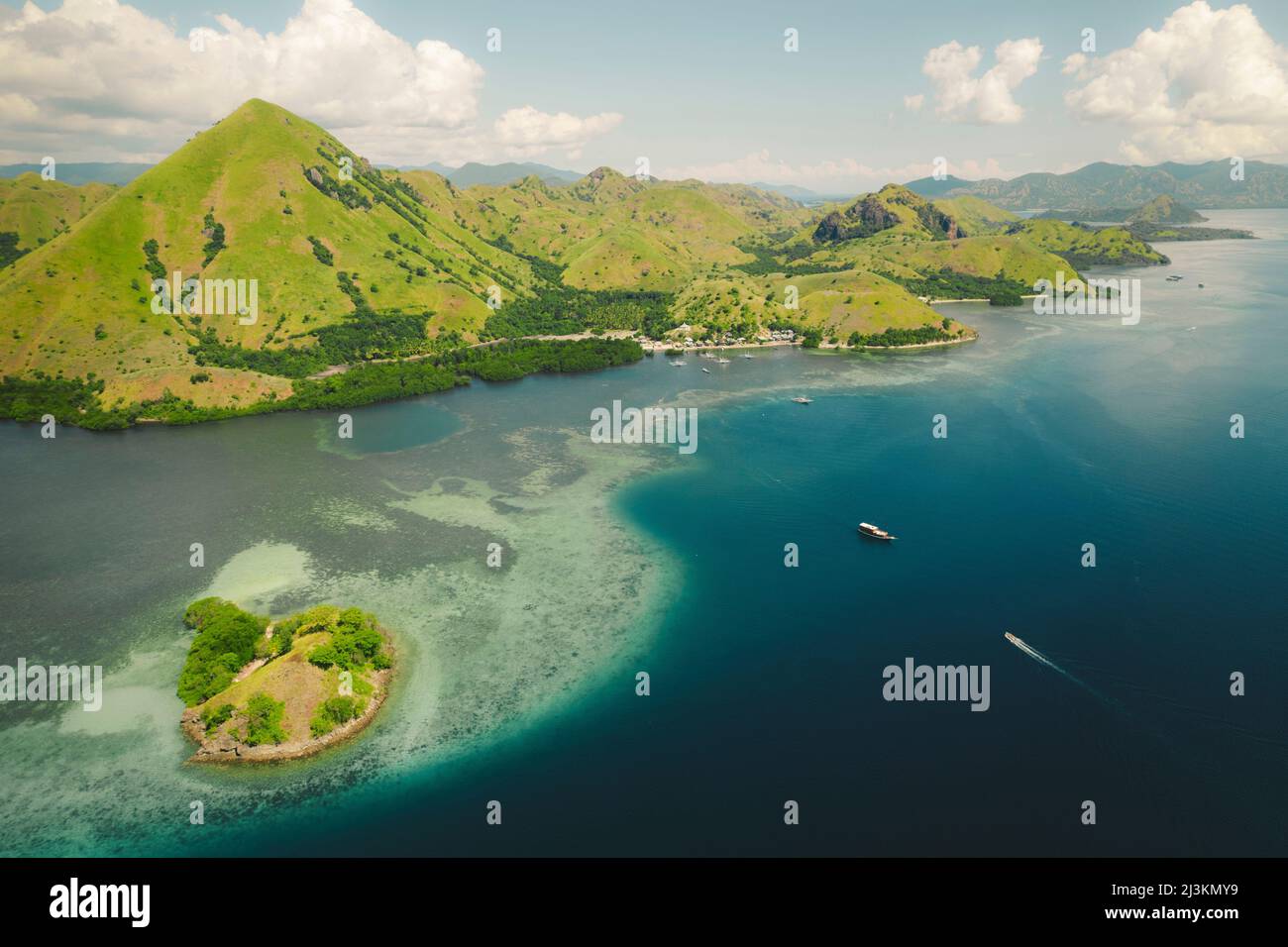 View of boats traveling to and from an island in Komodo National Park ...