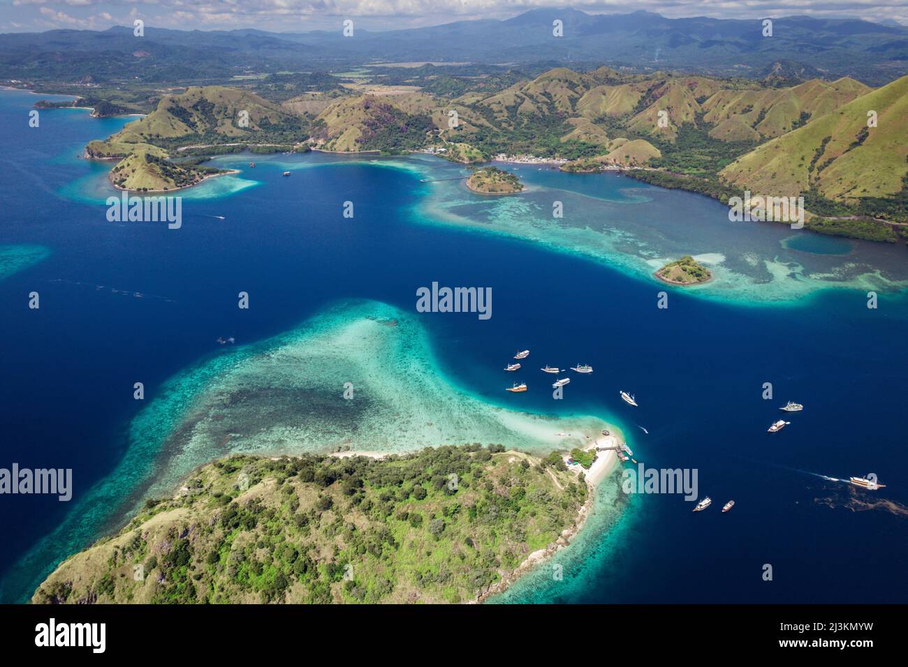 Aerial view of boats moored along the shore of an island in the Komodo ...